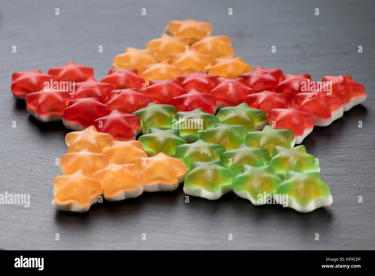Star shape gummy candy on dark background Stock Photo - Alamy