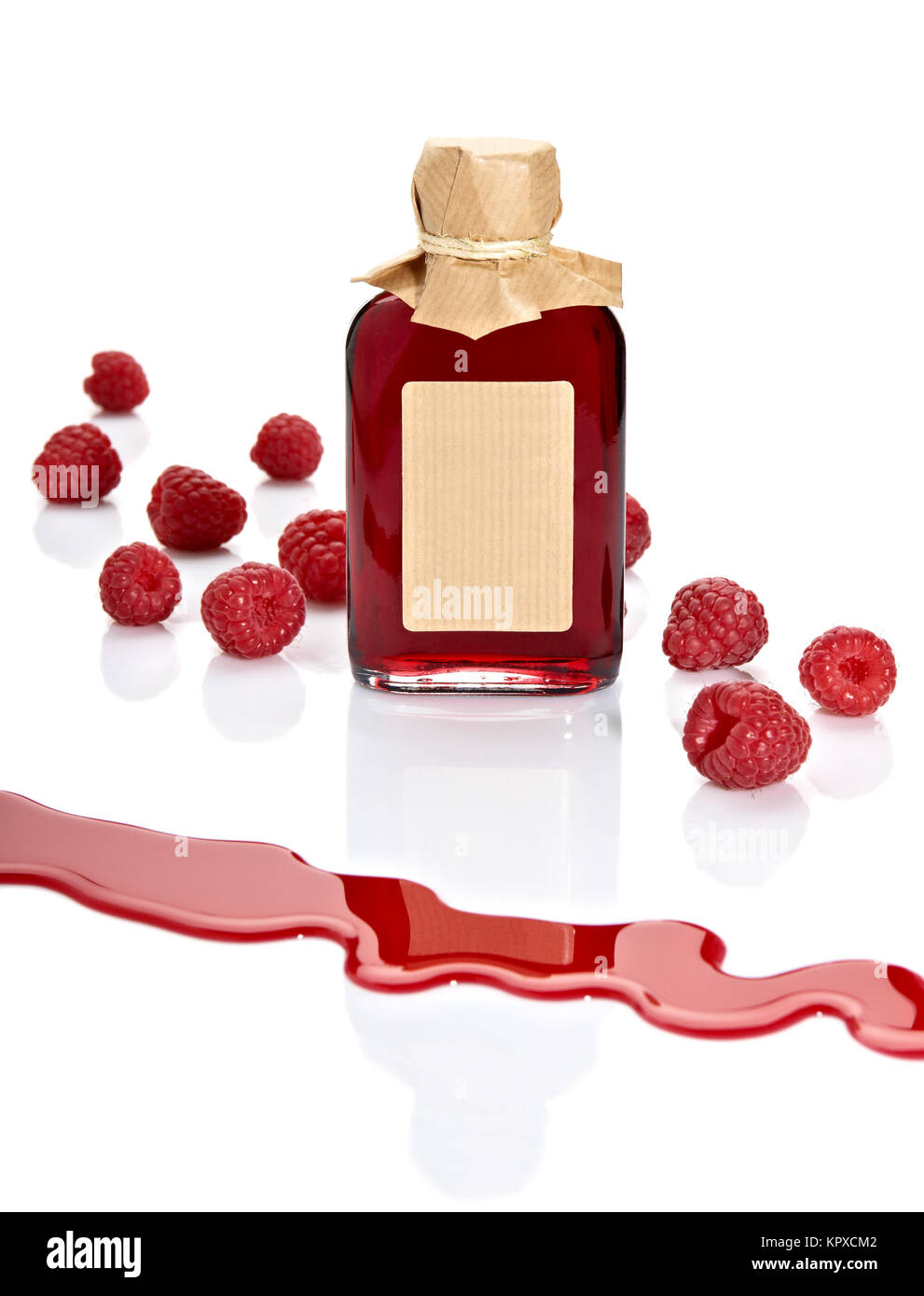 Raspberry juice in small bottle Stock Photo - Alamy