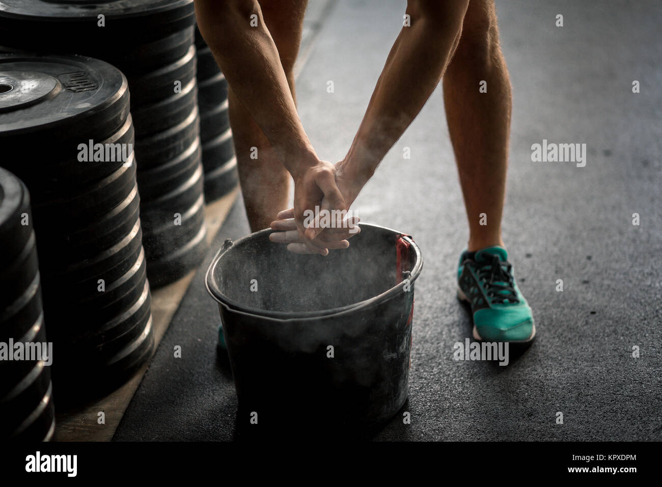 male powerlifter hand in talc and sports wristbands preparing to bench ...