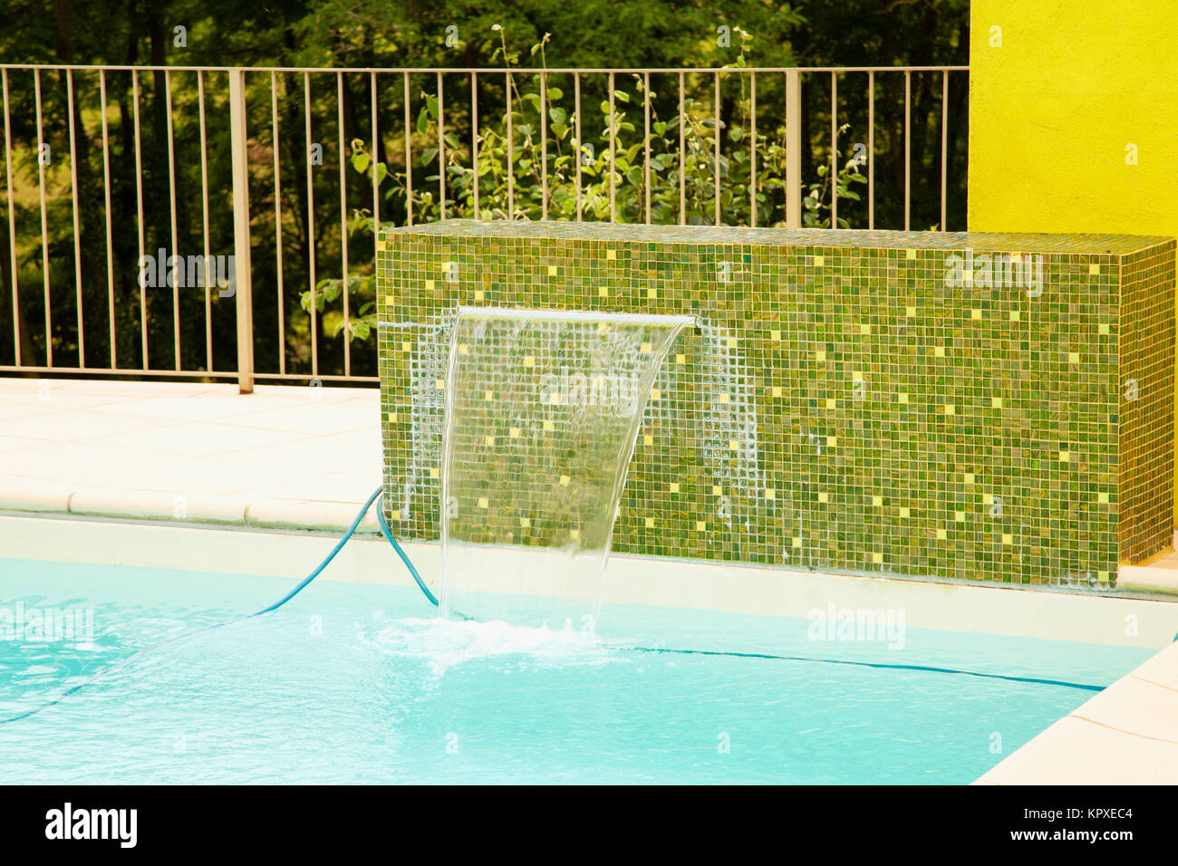 Cascade of water spilling to a pool Stock Photo - Alamy