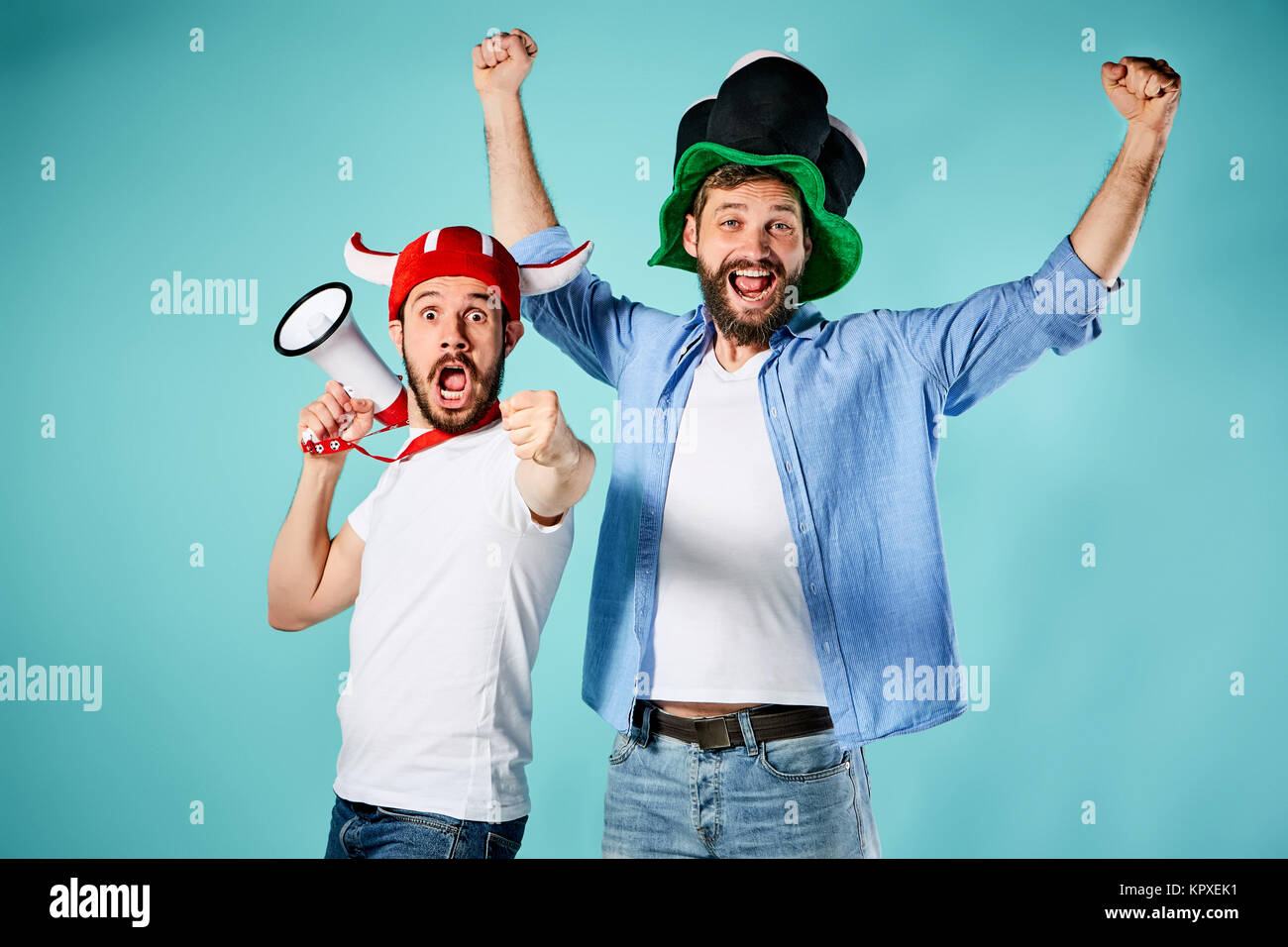 The two football fans with mouthpiece over blue Stock Photo - Alamy