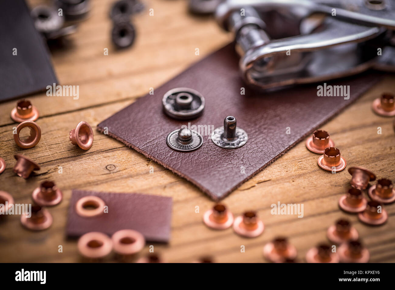 Punch tool and buckles Stock Photo - Alamy