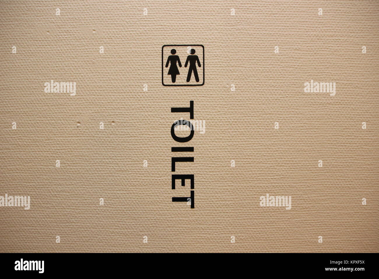 Unisex Toilet Sign on White Structured Wall Stock Photo - Alamy