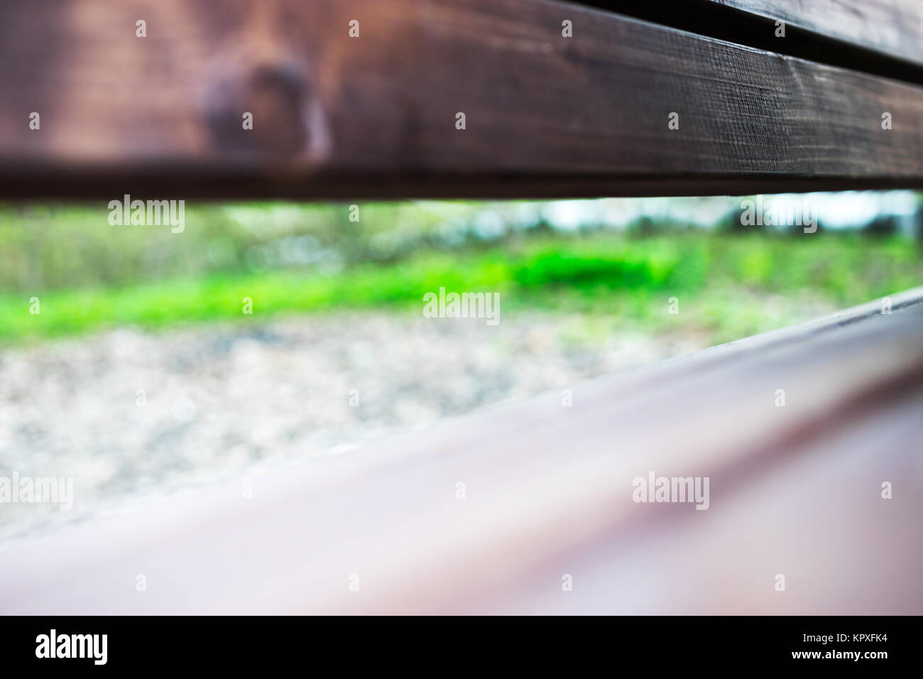 Diagonal park bench bokeh background Stock Photo - Alamy
