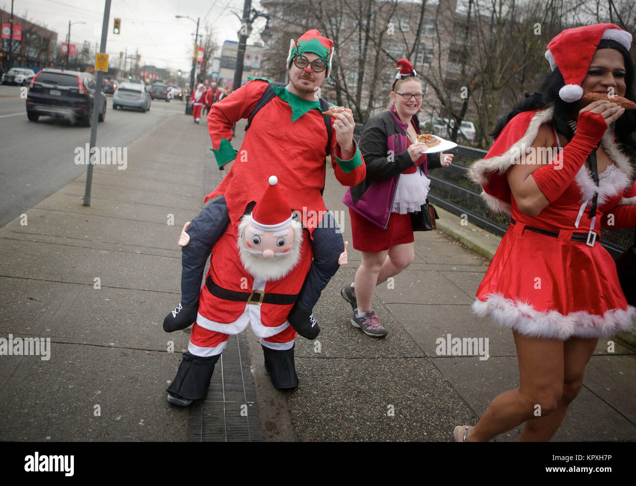 Vancouver. 16th Dec, 2017. Revellers dressed in Santa Claus' costumes ...