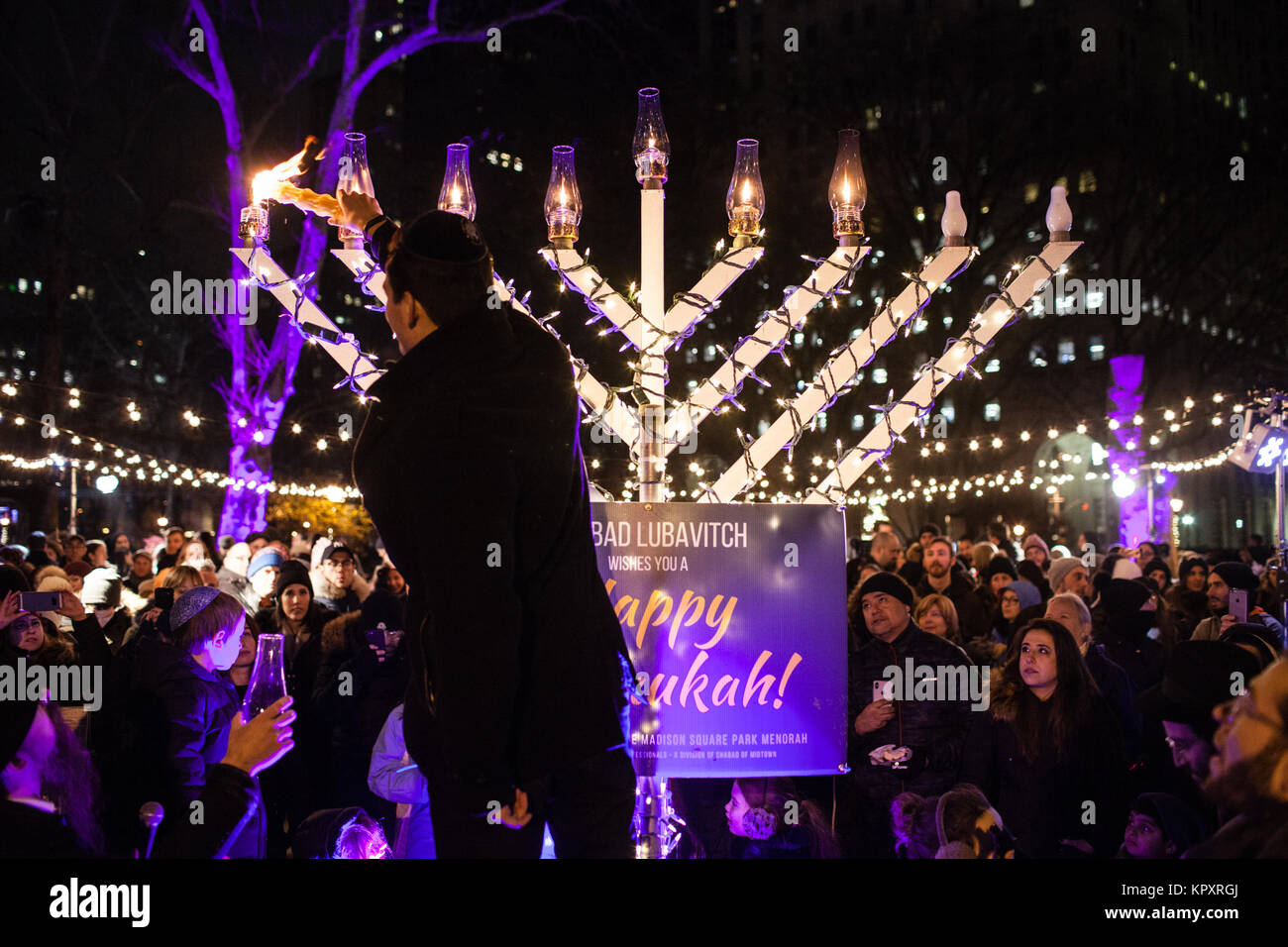 New York, New York, USA. 17th Dec, 2017. JONATHAN HABER, 26, lights a ...
