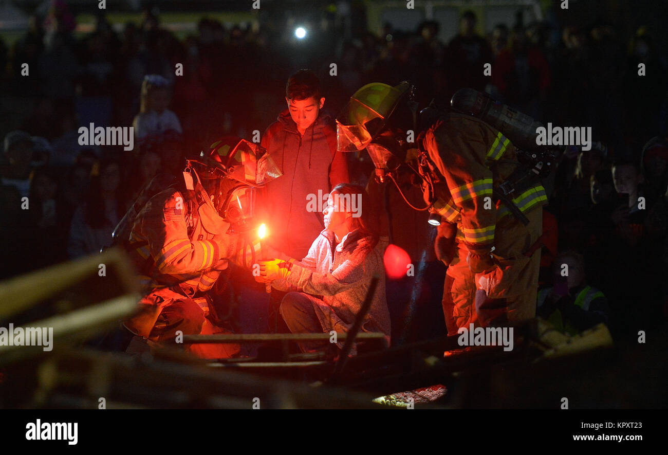U.S. 17th Dec, 2017. -- Jamie Lattin, center, hands a flare to her son ...