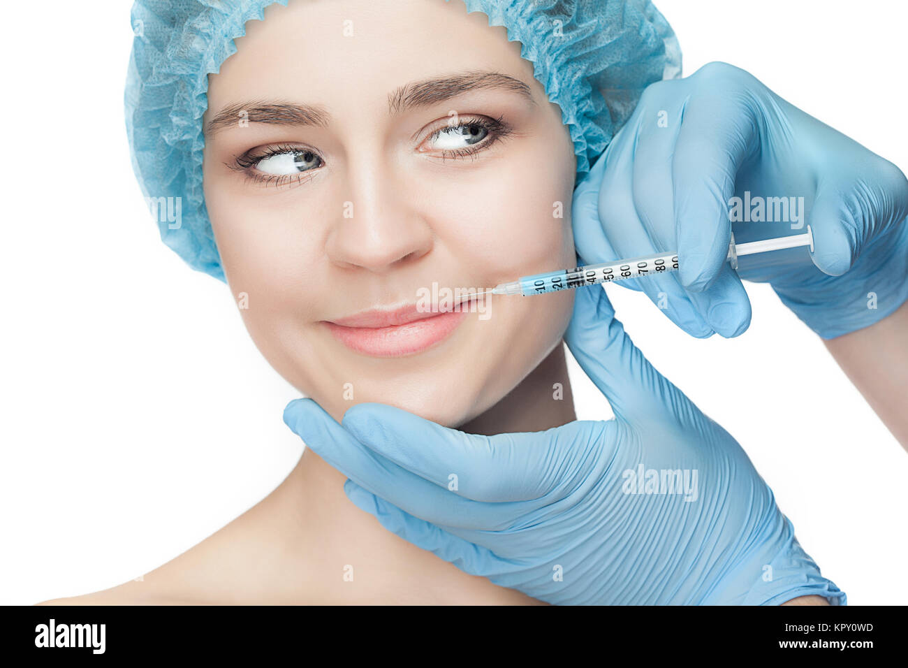 Attractive woman at plastic surgery with syringe in her face Stock ...