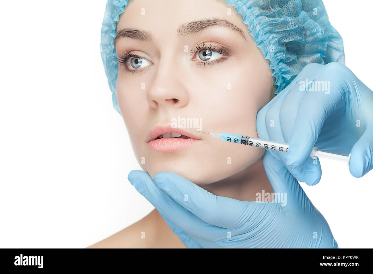 Attractive woman at plastic surgery with syringe in her face Stock ...