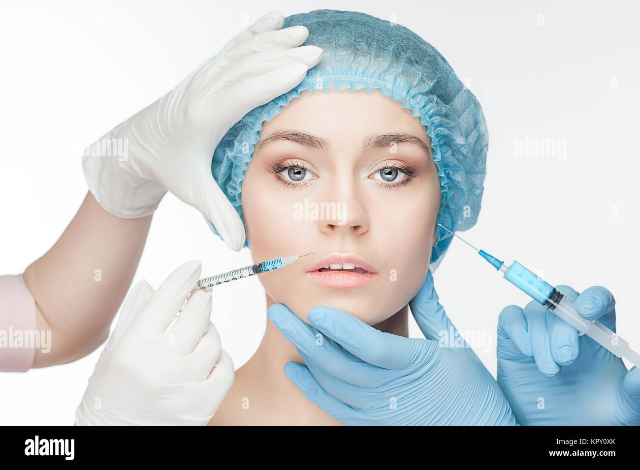 Attractive woman at plastic surgery with syringe in her face Stock ...