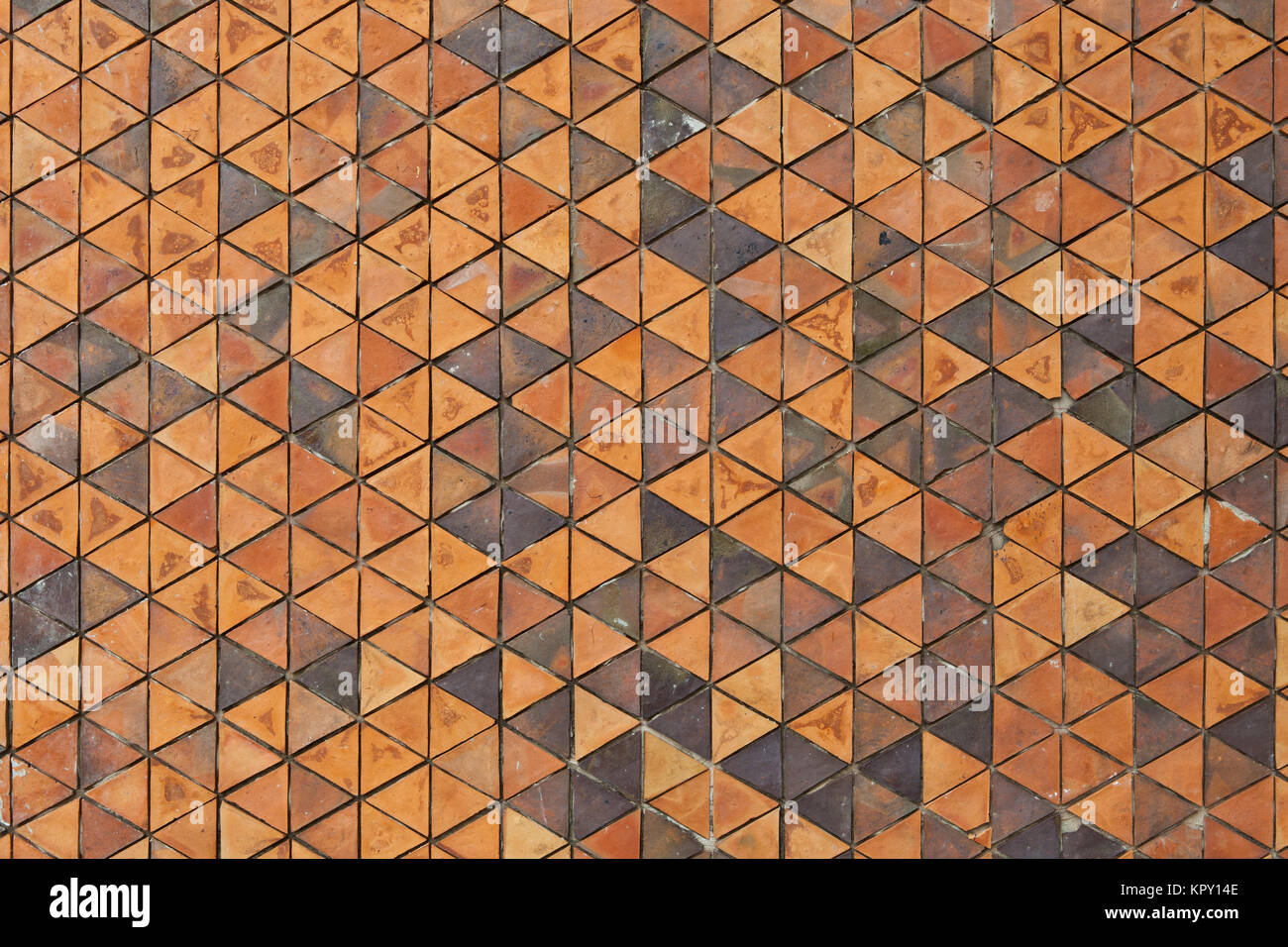 Pattern of triangular clay tiles background, orange wall, terra cotta ...