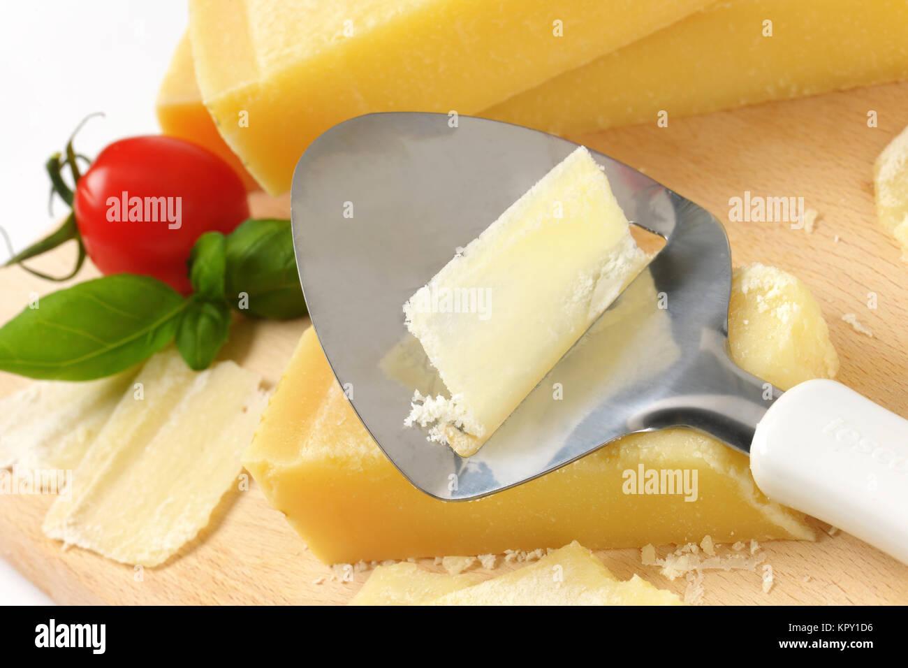 cheese slicer on parmesan cheese Stock Photo - Alamy