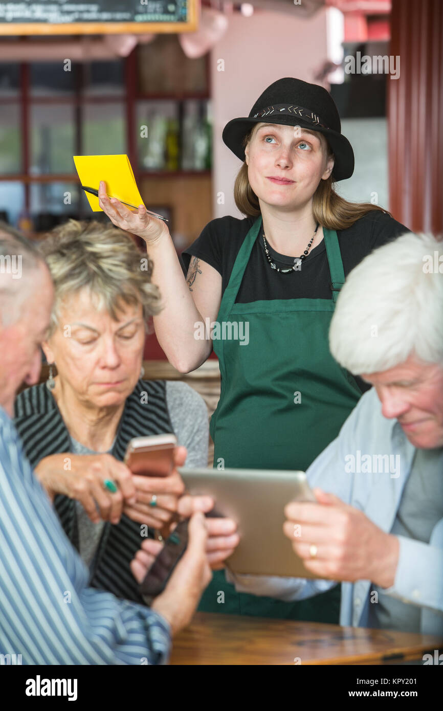 Mature woman cafe phone apron hi-res stock photography and images - Alamy