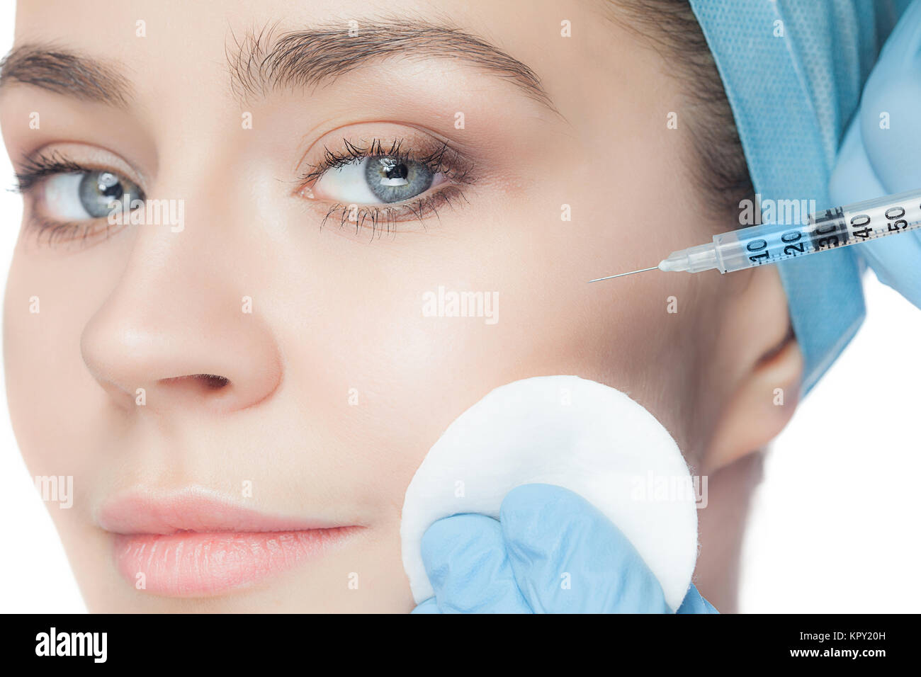 Attractive woman at plastic surgery with syringe in her face Stock ...