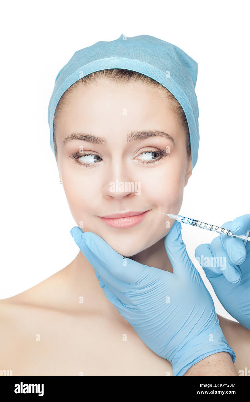 Attractive woman at plastic surgery with syringe in her face Stock ...