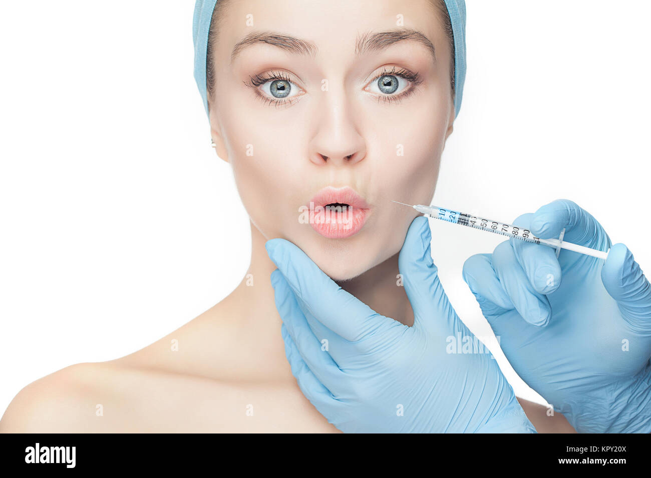 Attractive woman at plastic surgery with syringe in her face Stock ...