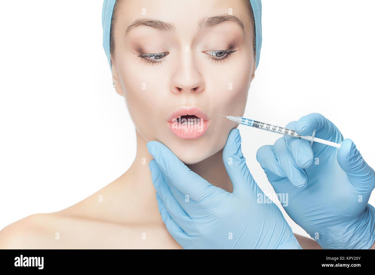 Attractive woman at plastic surgery with syringe in her face Stock ...