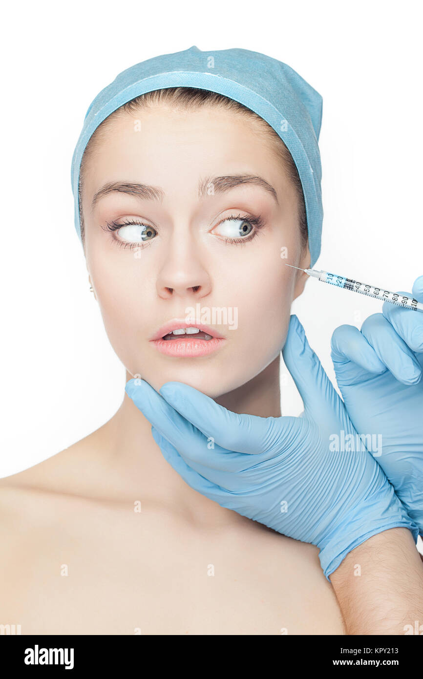 Attractive woman at plastic surgery with syringe in her face Stock ...