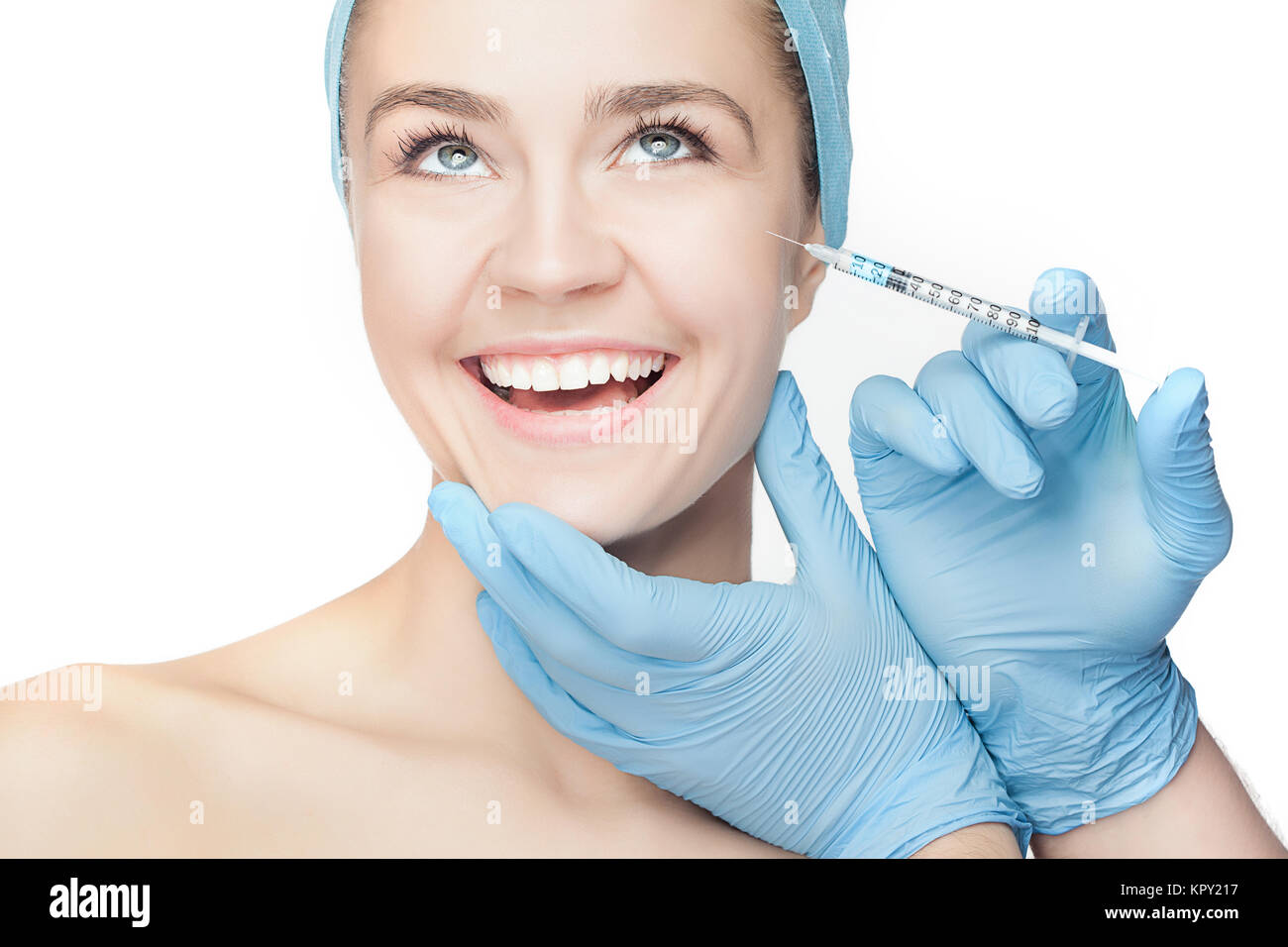 Attractive woman at plastic surgery with syringe in her face Stock ...