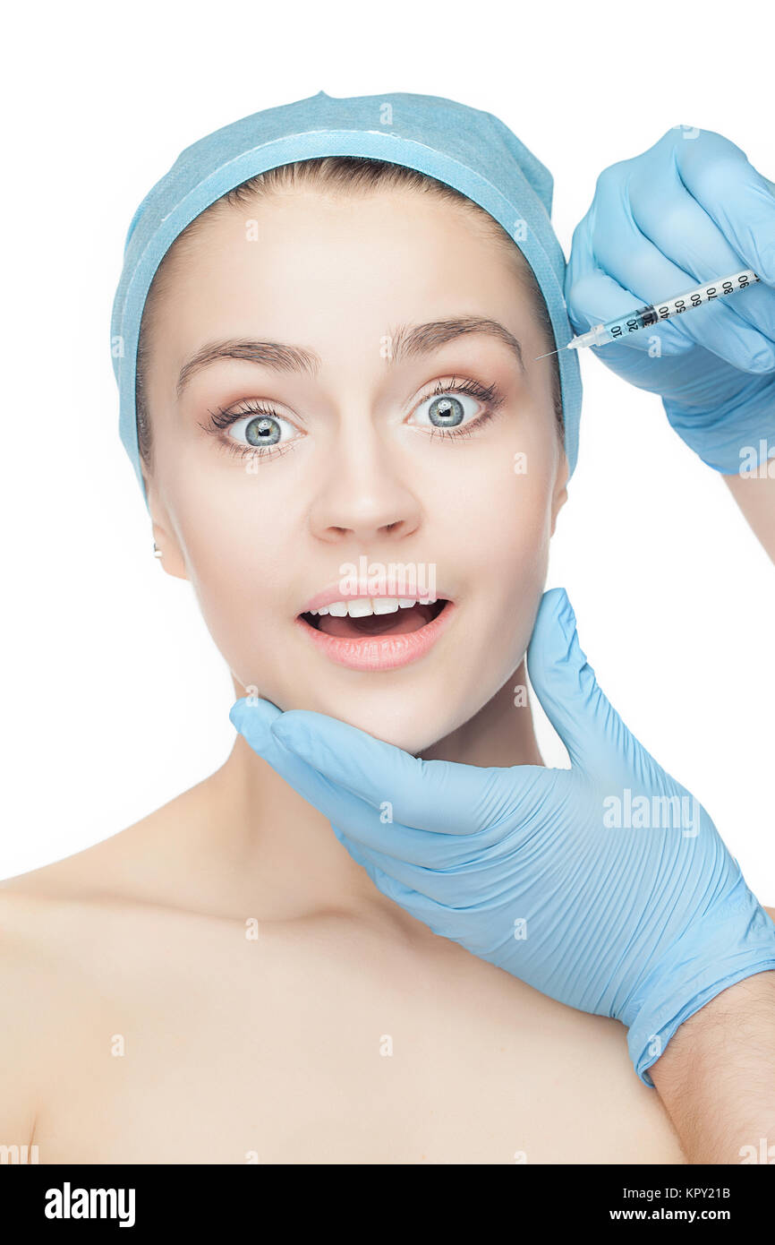 Attractive woman at plastic surgery with syringe in her face Stock ...