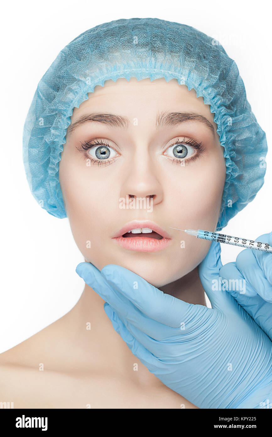 Attractive woman at plastic surgery with syringe in her face Stock ...