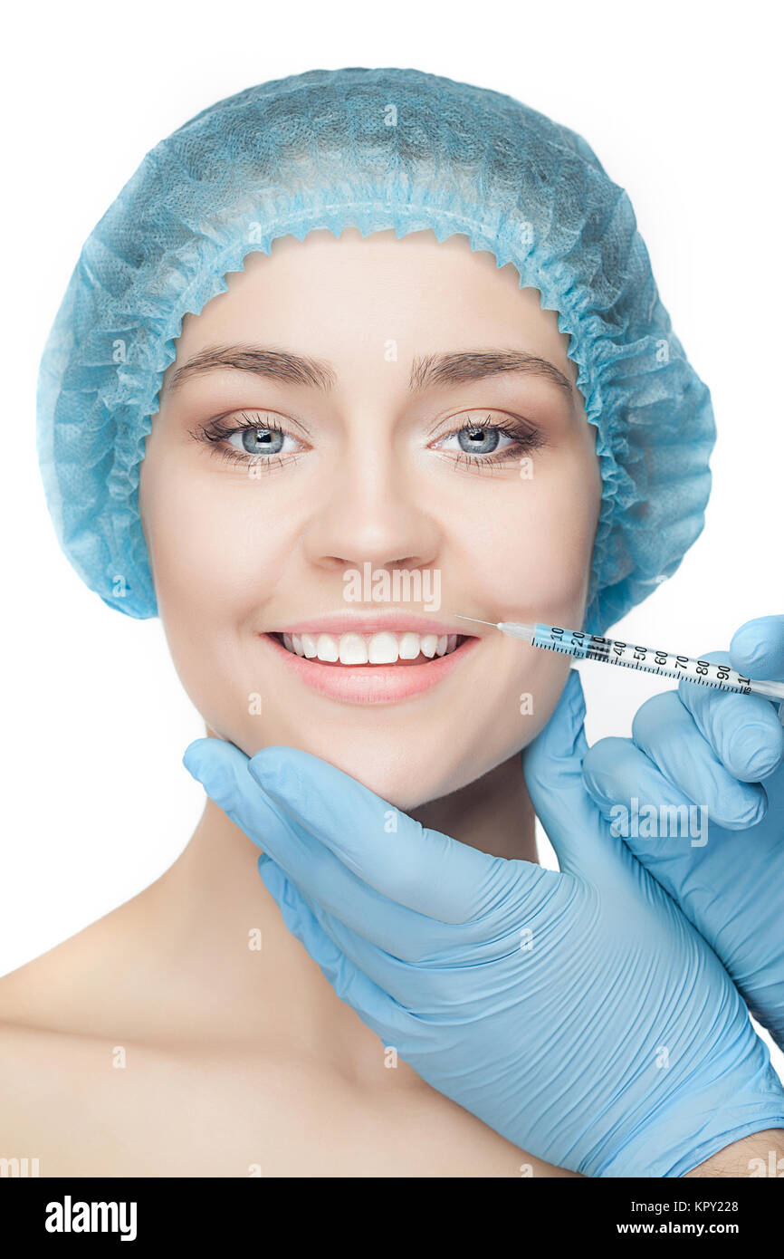 Attractive woman at plastic surgery with syringe in her face Stock ...