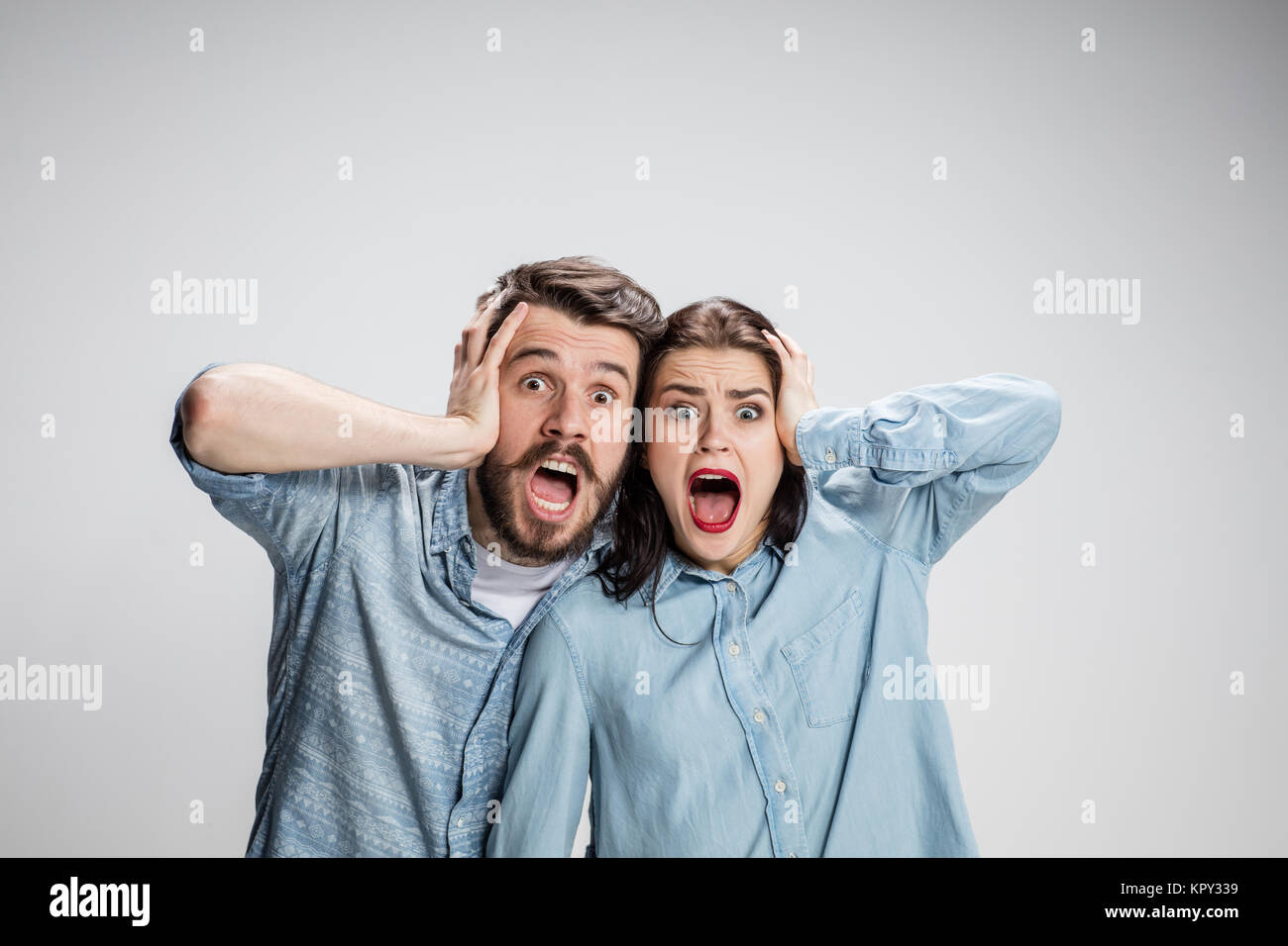 Close up photo of angry man and woman touching their heads Stock Photo ...