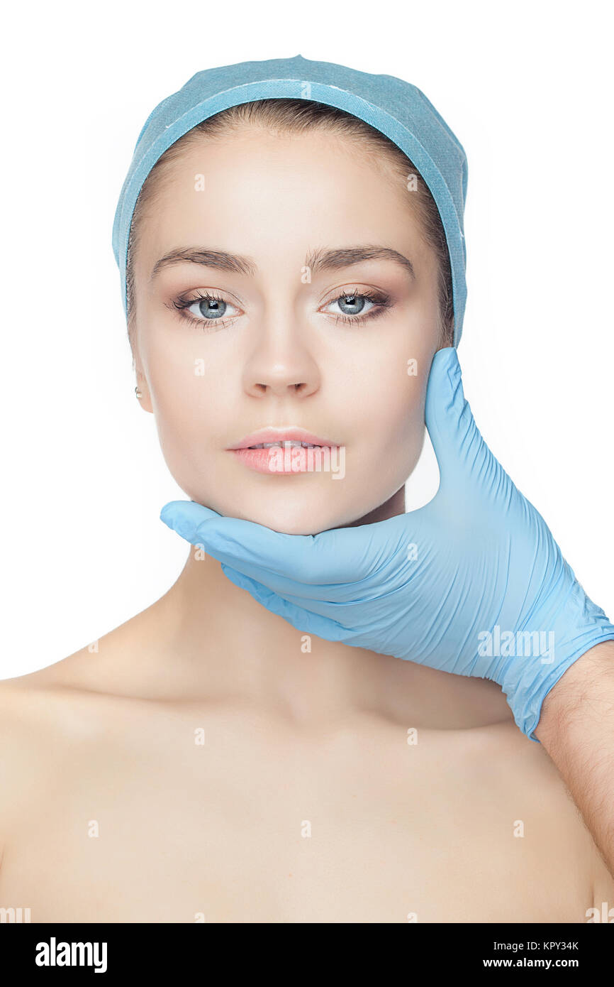 Plastic surgery concept. Doctor hands in gloves touching woman face ...