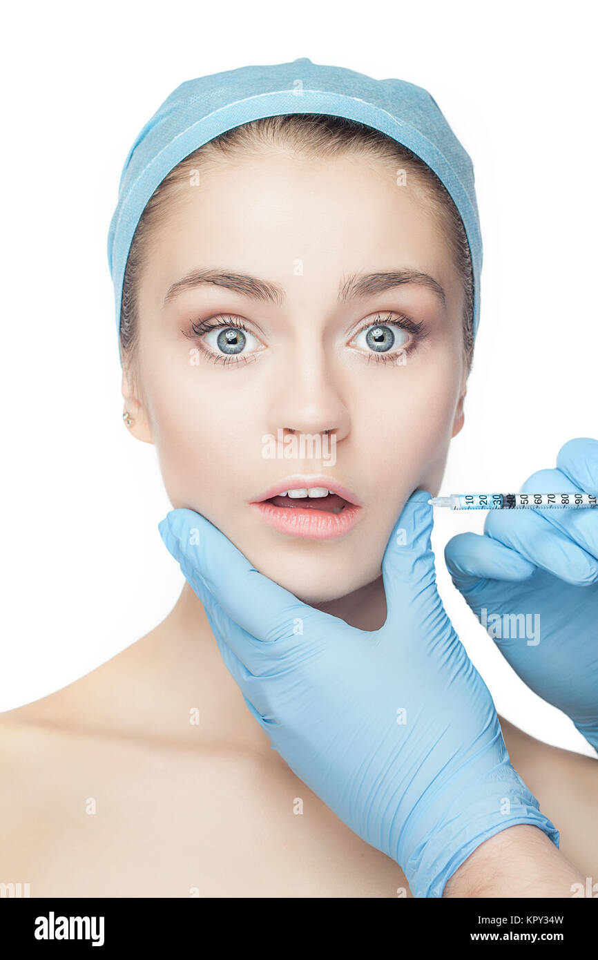 Attractive woman at plastic surgery with syringe in her face Stock ...
