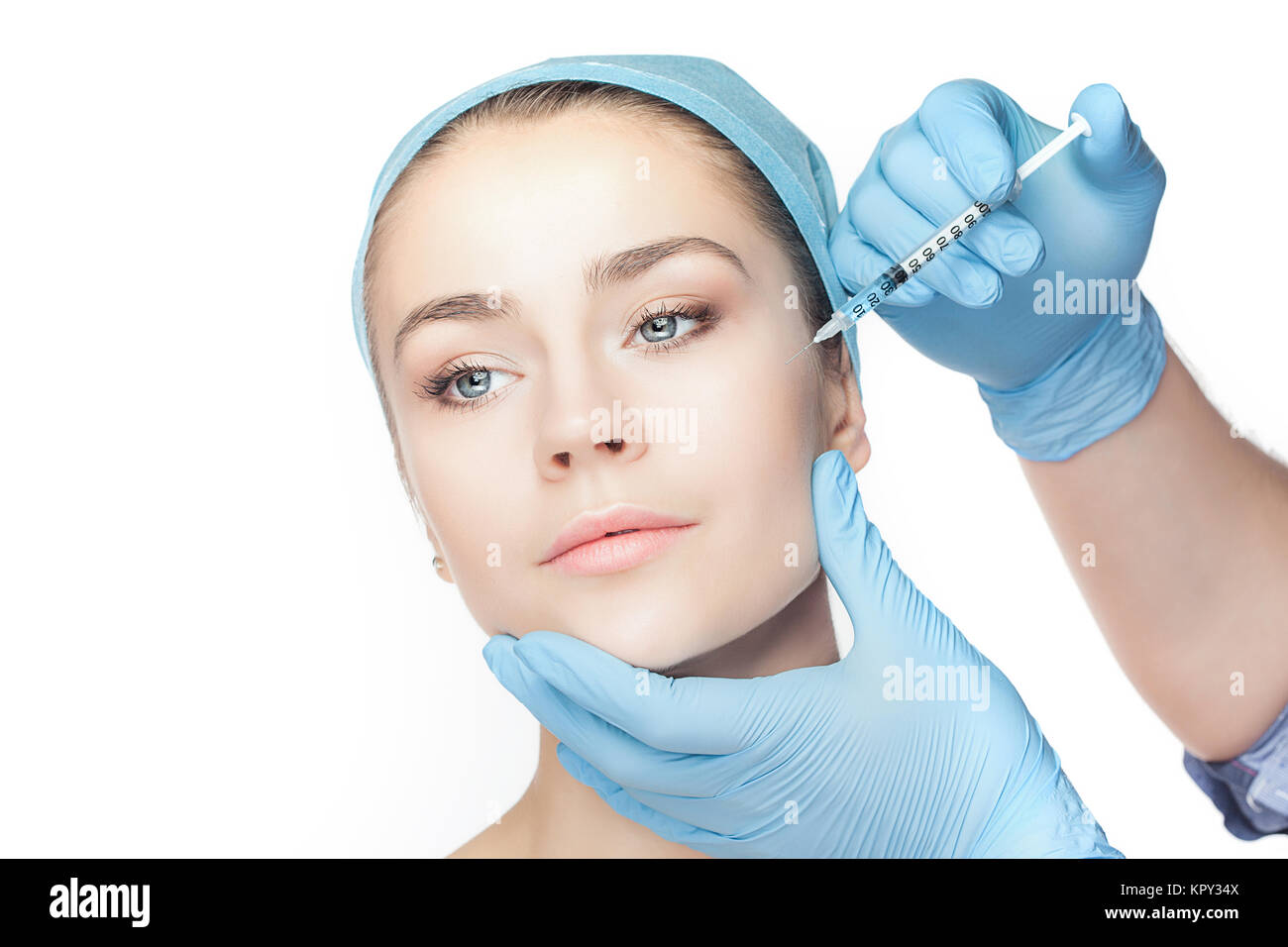 Attractive woman at plastic surgery with syringe in her face Stock ...