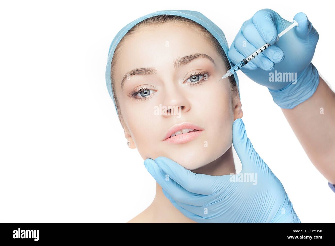 Attractive woman at plastic surgery with syringe in her face Stock ...
