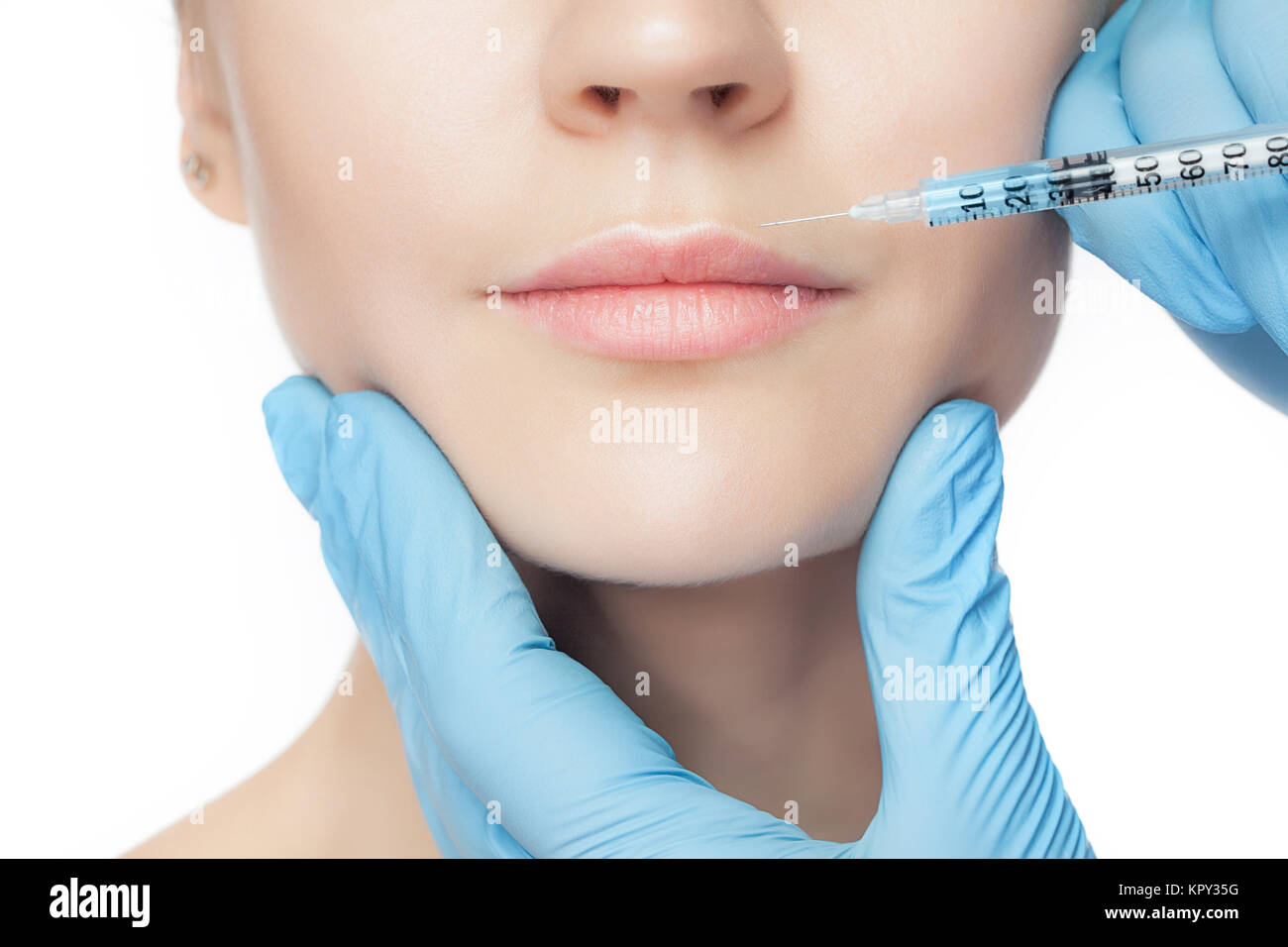 Attractive woman at plastic surgery with syringe in her face Stock ...