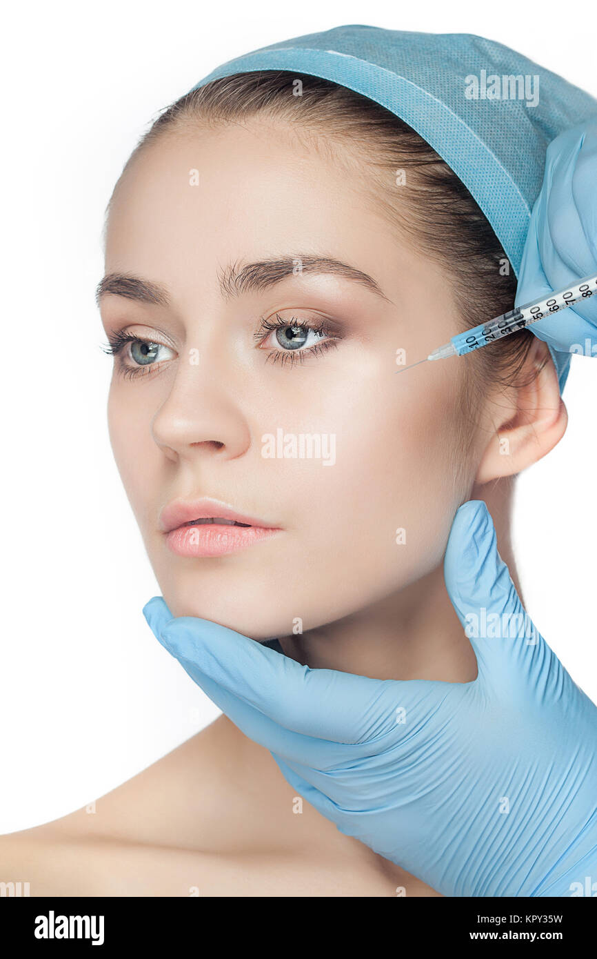 Attractive woman at plastic surgery with syringe in her face Stock ...
