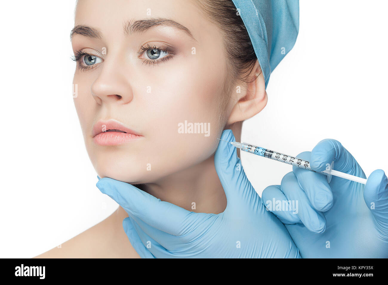Attractive woman at plastic surgery with syringe in her face Stock ...