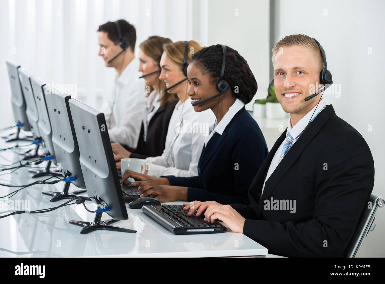 Businesspeople Working In Call Center Stock Photo - Alamy