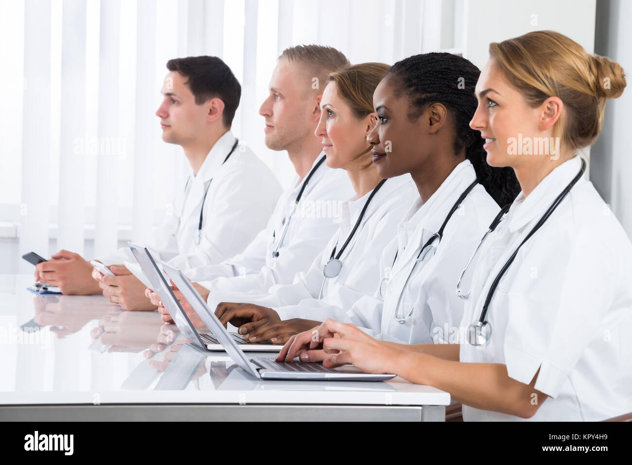 Doctors Using Laptop In Meeting Stock Photo - Alamy
