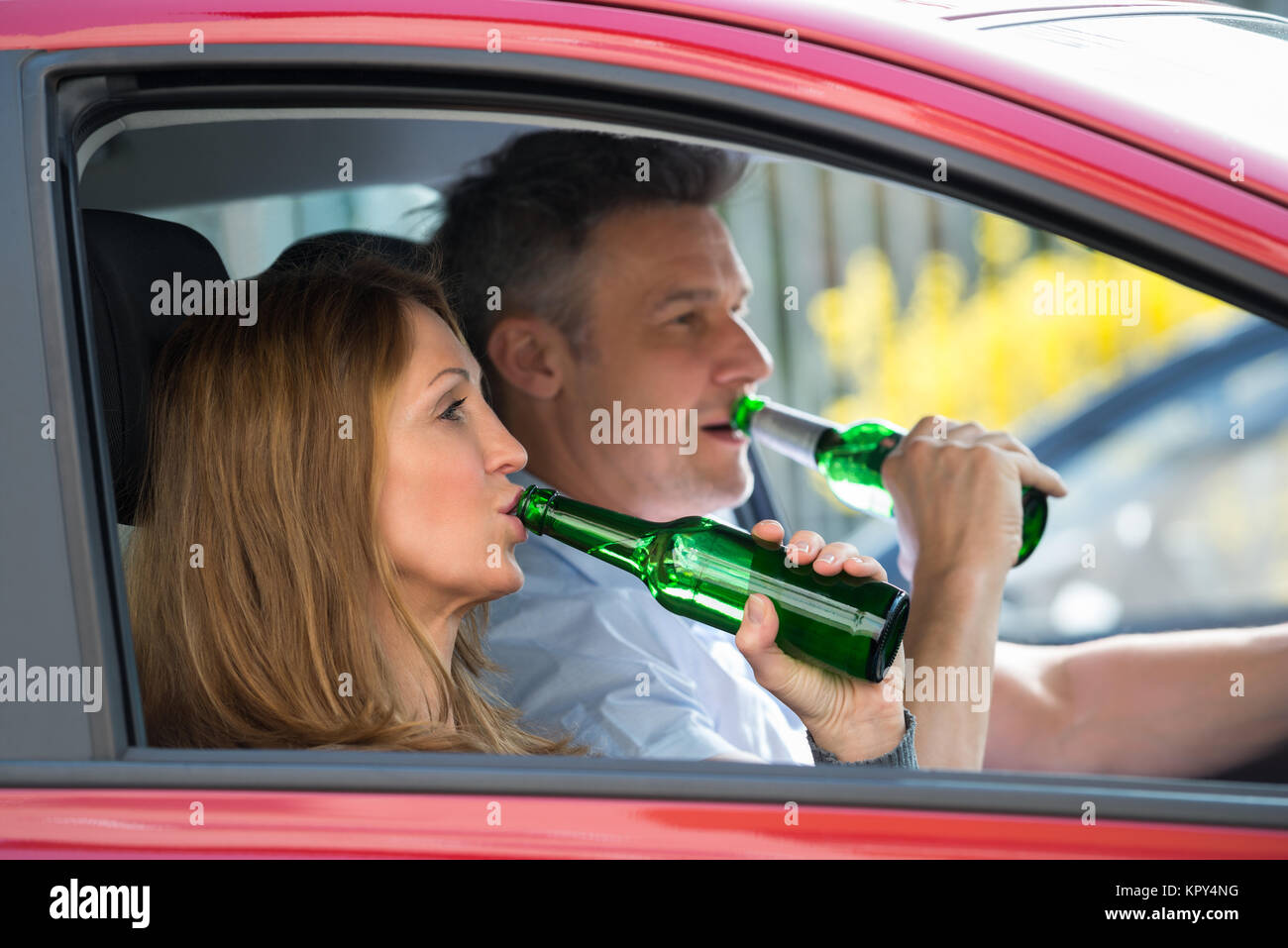 Couple Drinking Alcohol In Car Stock Photo - Alamy
