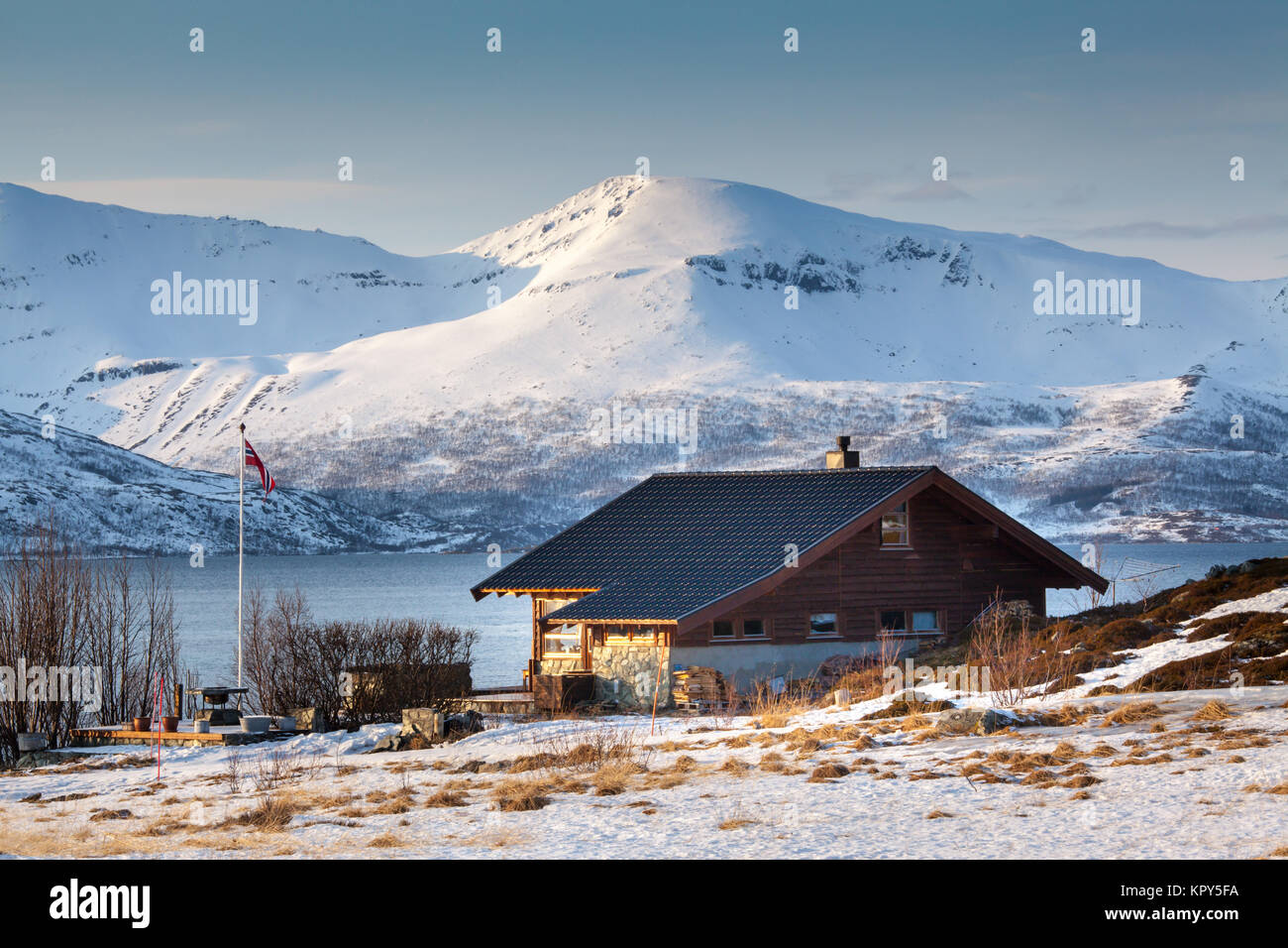 Isolated home and beach on a snowy lake Stock Photo - Alamy
