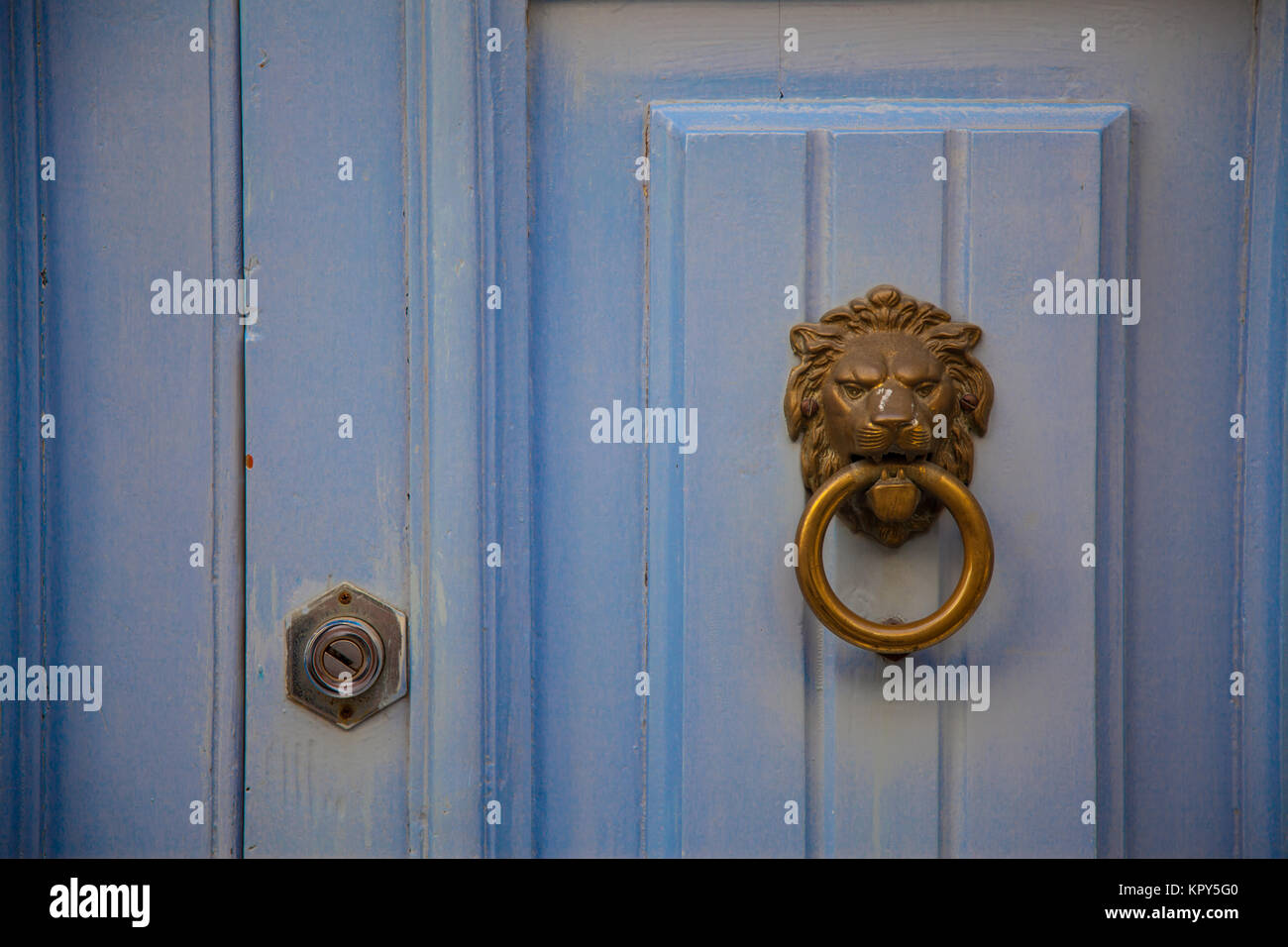 A handmade lionhead doorknob on a cyan wood door with his lock Stock ...
