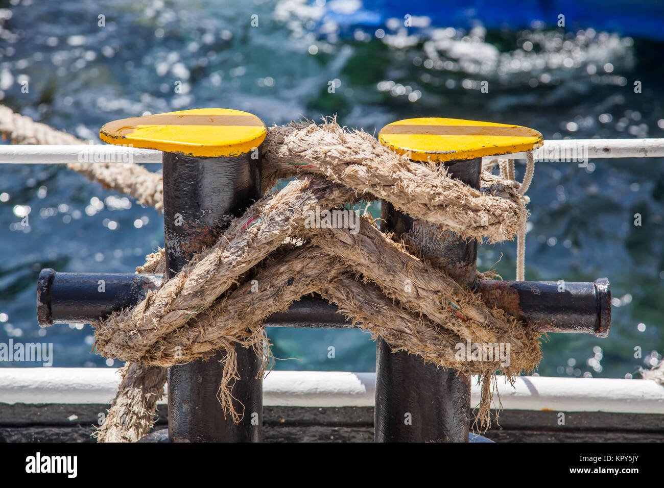 Knotted weathered boat ropes on a blue sea Stock Photo - Alamy