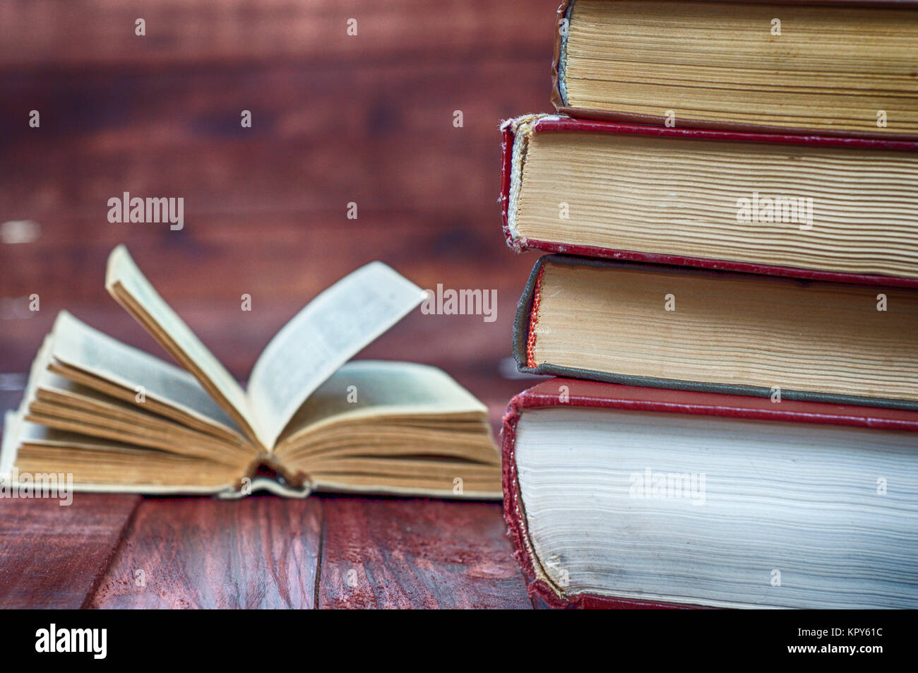 stack of books against the background of an open book Stock Photo - Alamy
