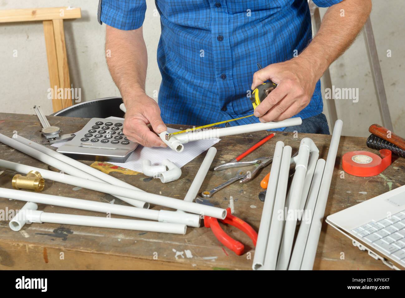man measuring a plastic pipe, close up Stock Photo - Alamy