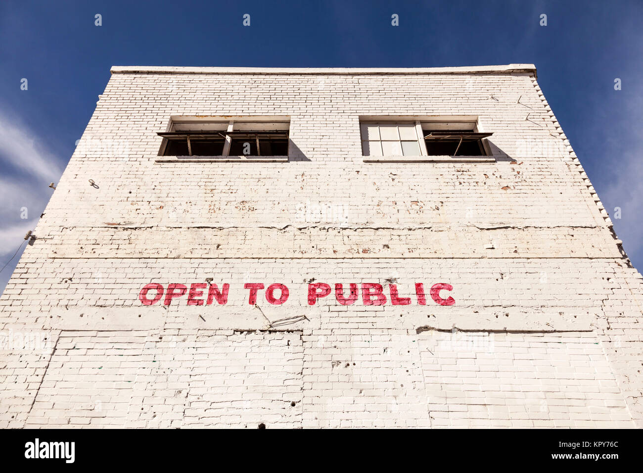 Open to public writing on a white building Stock Photo - Alamy