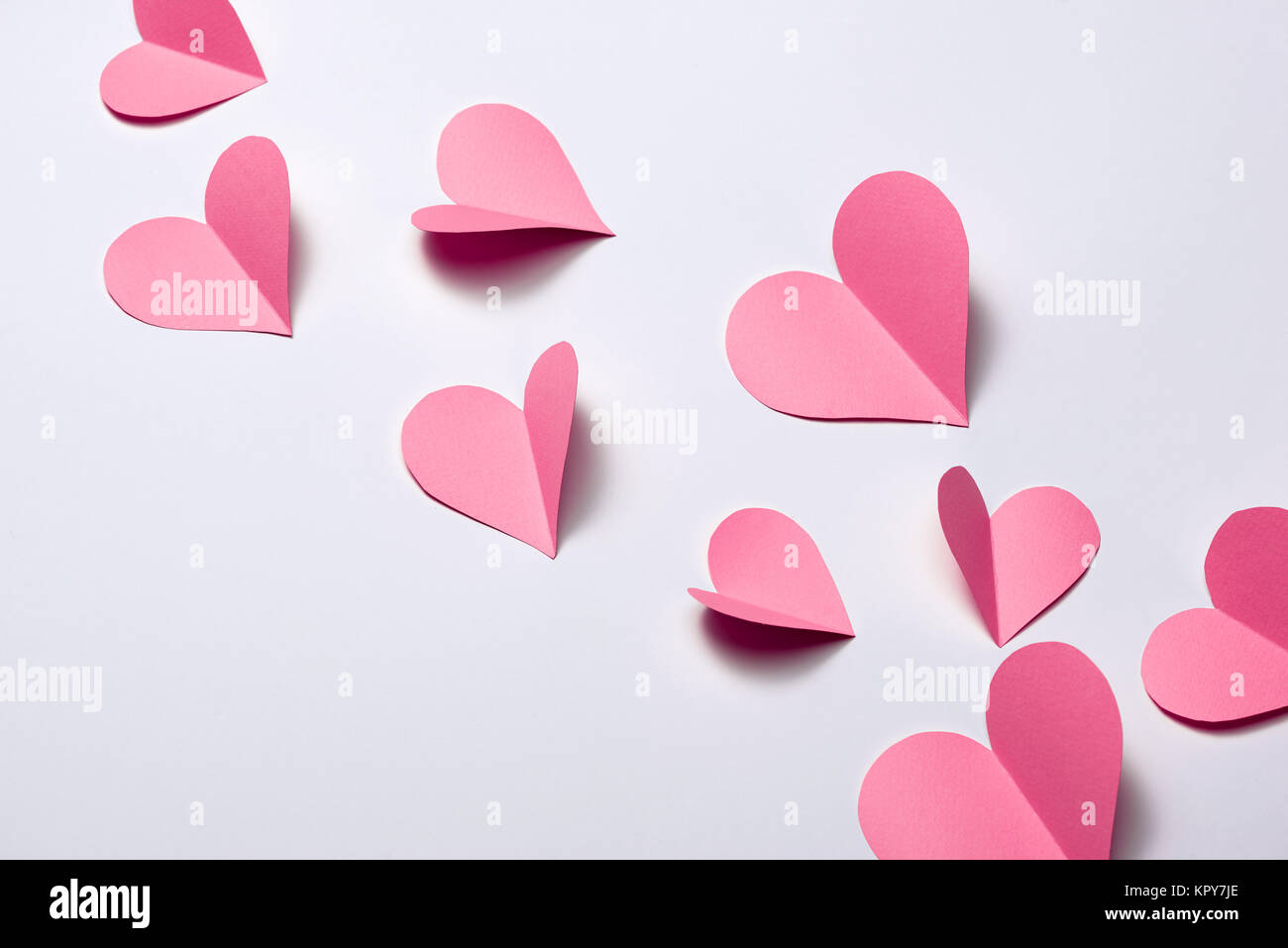Beautiful pink paper hearts on white paper background Stock Photo - Alamy