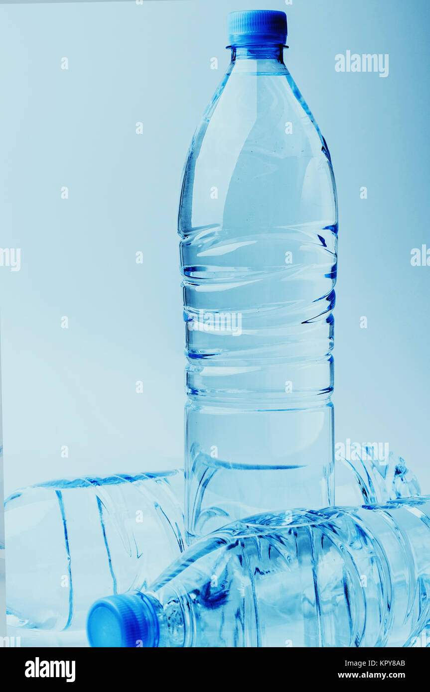 Three bottles of water on a gradient background Stock Photo - Alamy