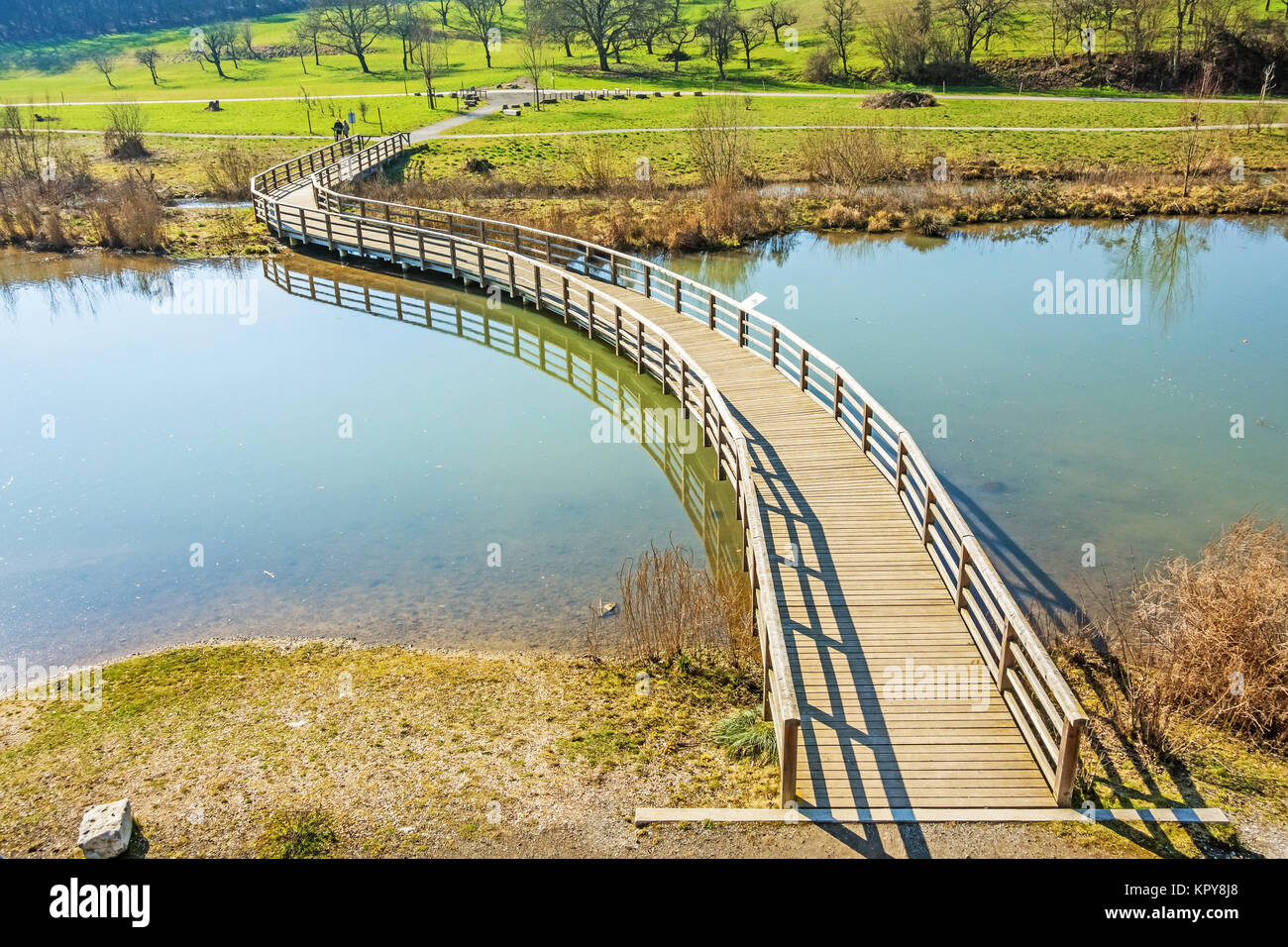 Path through rural landscape over water Stock Photo - Alamy