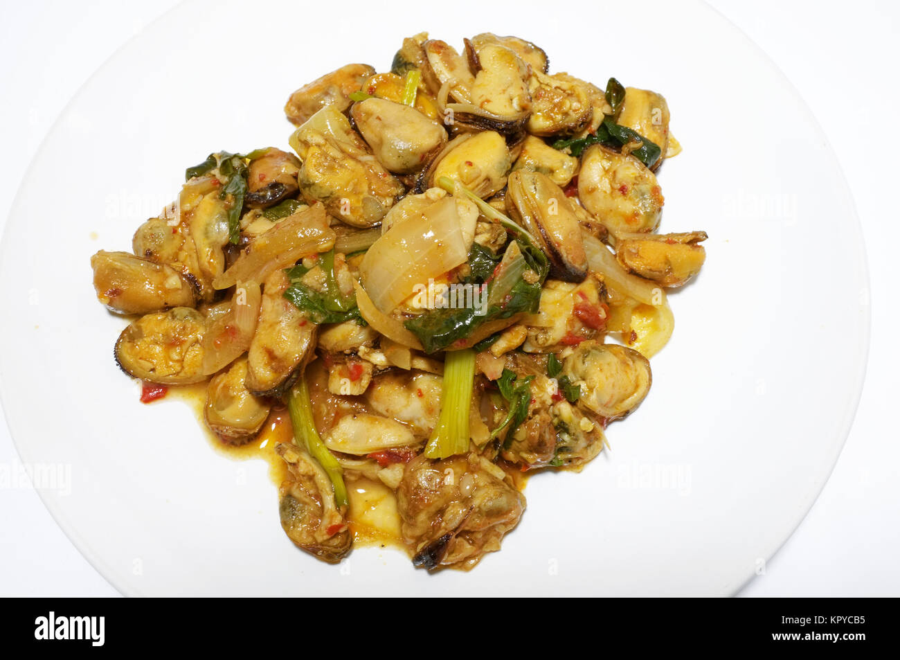Stir fried spicy mussel with herb, thai food Stock Photo - Alamy