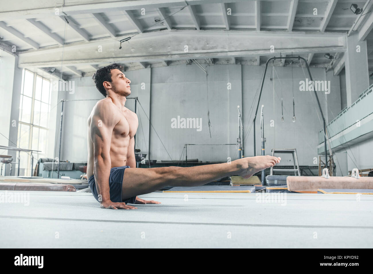 caucasian man gymnastic acrobatics equilibrium posture at gym ...
