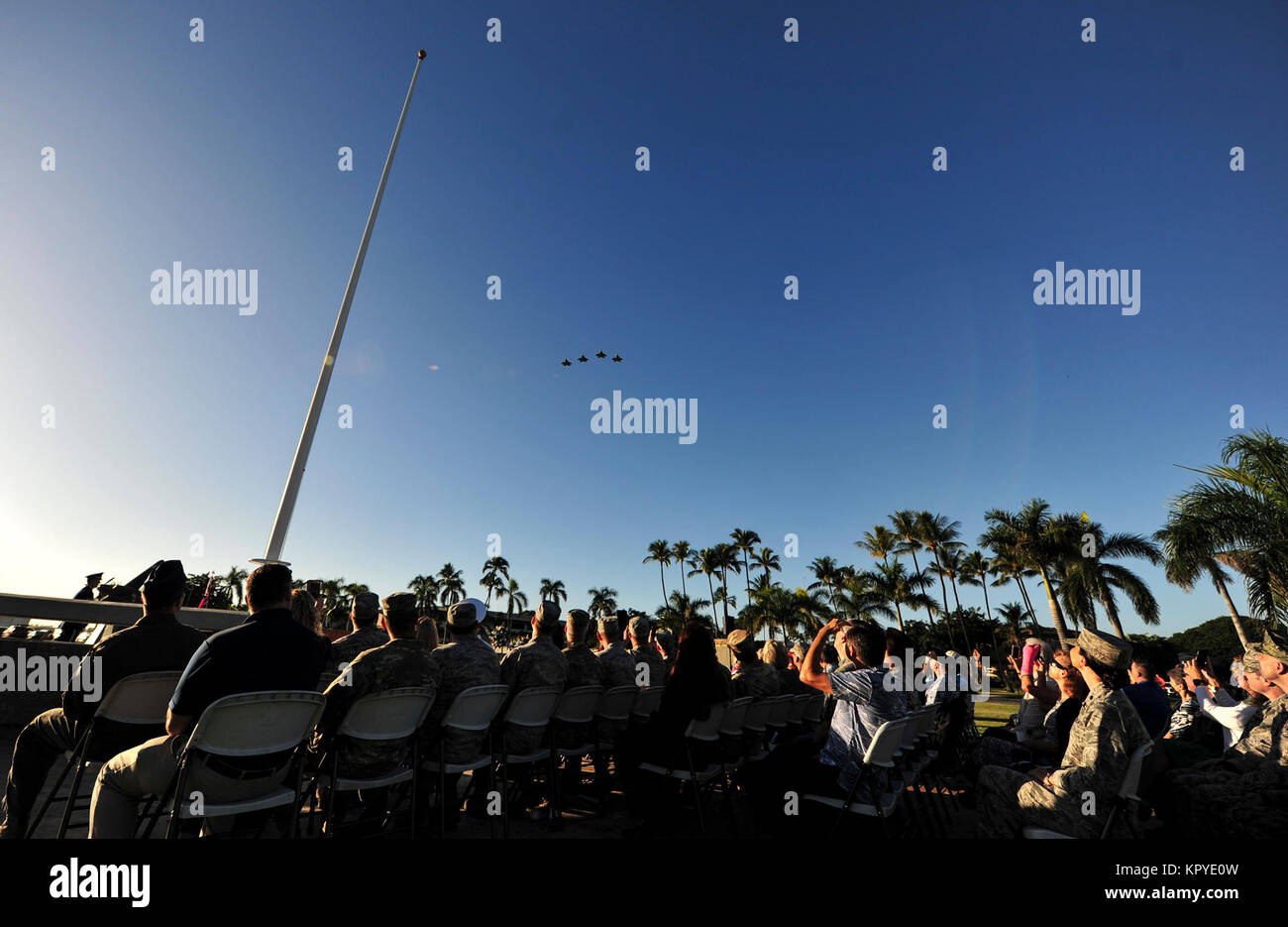 Spectators watch the F-22 Raptor missing man formation fly over during ...