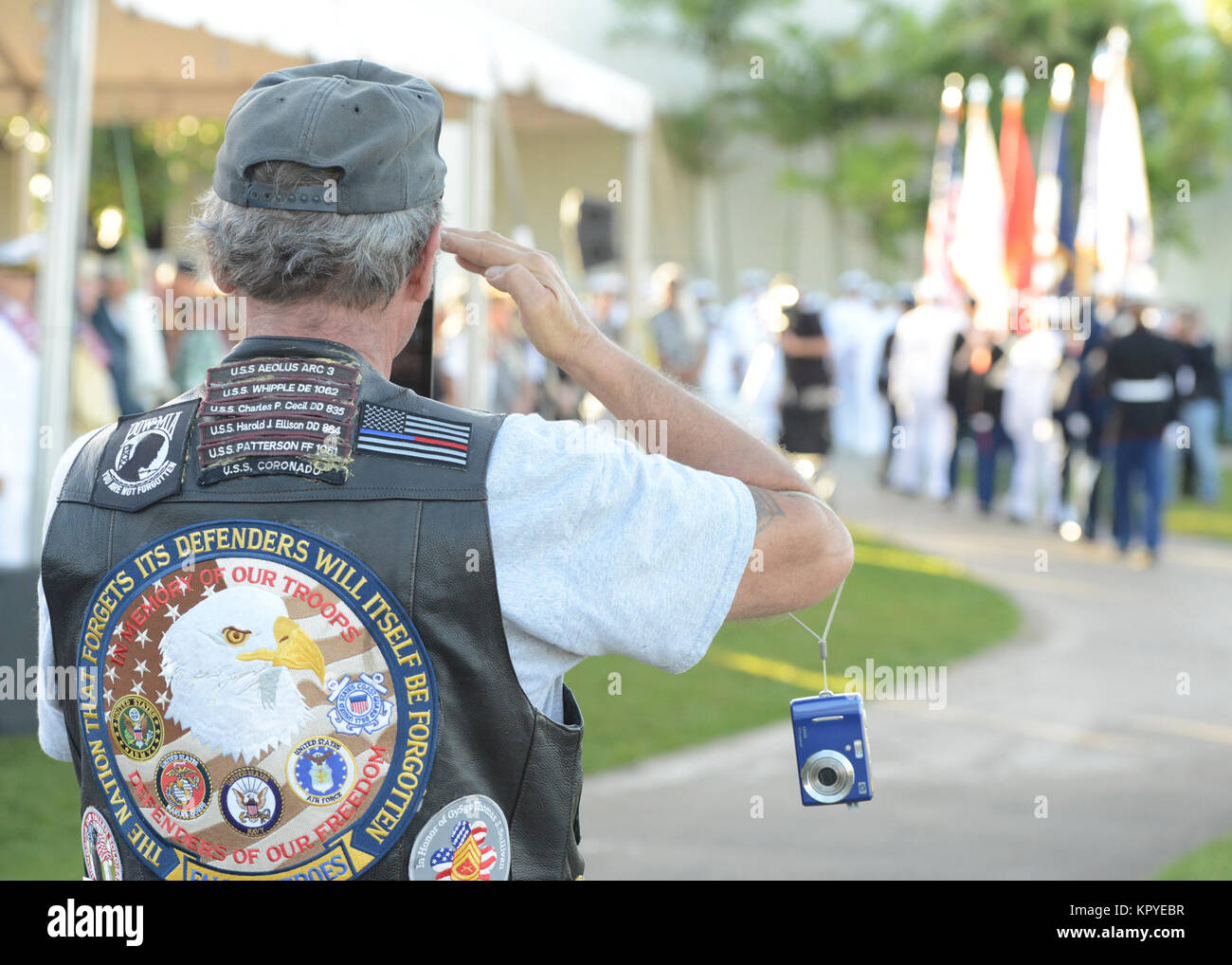 A military veteran salutes after the presentation of colors from the U ...
